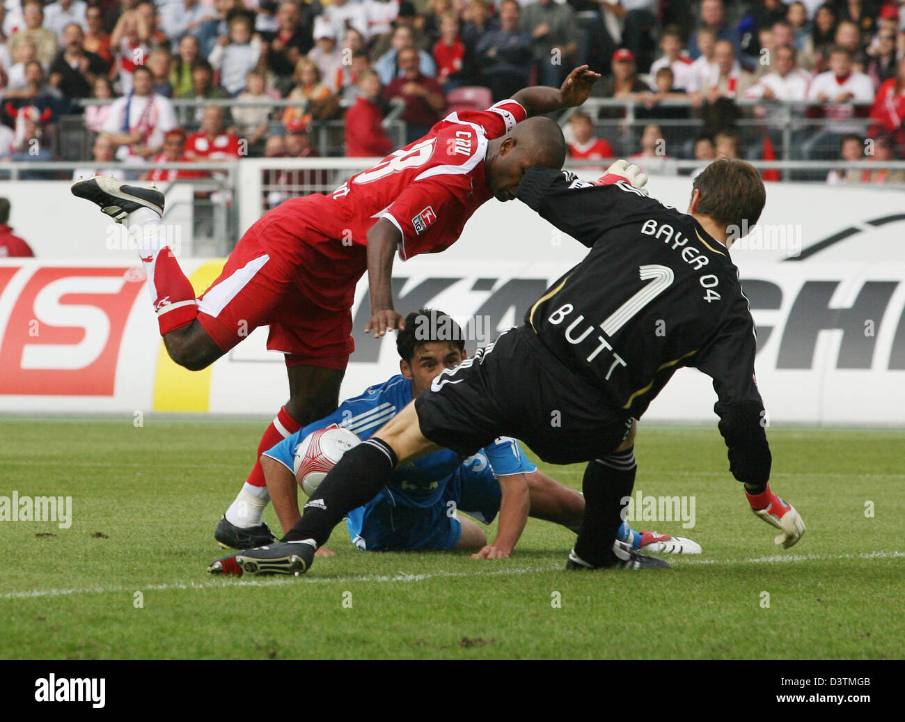 Cacau of Stuttgart (C) and Leverkusen's goalie Joerg Butt (R) and Karim ...