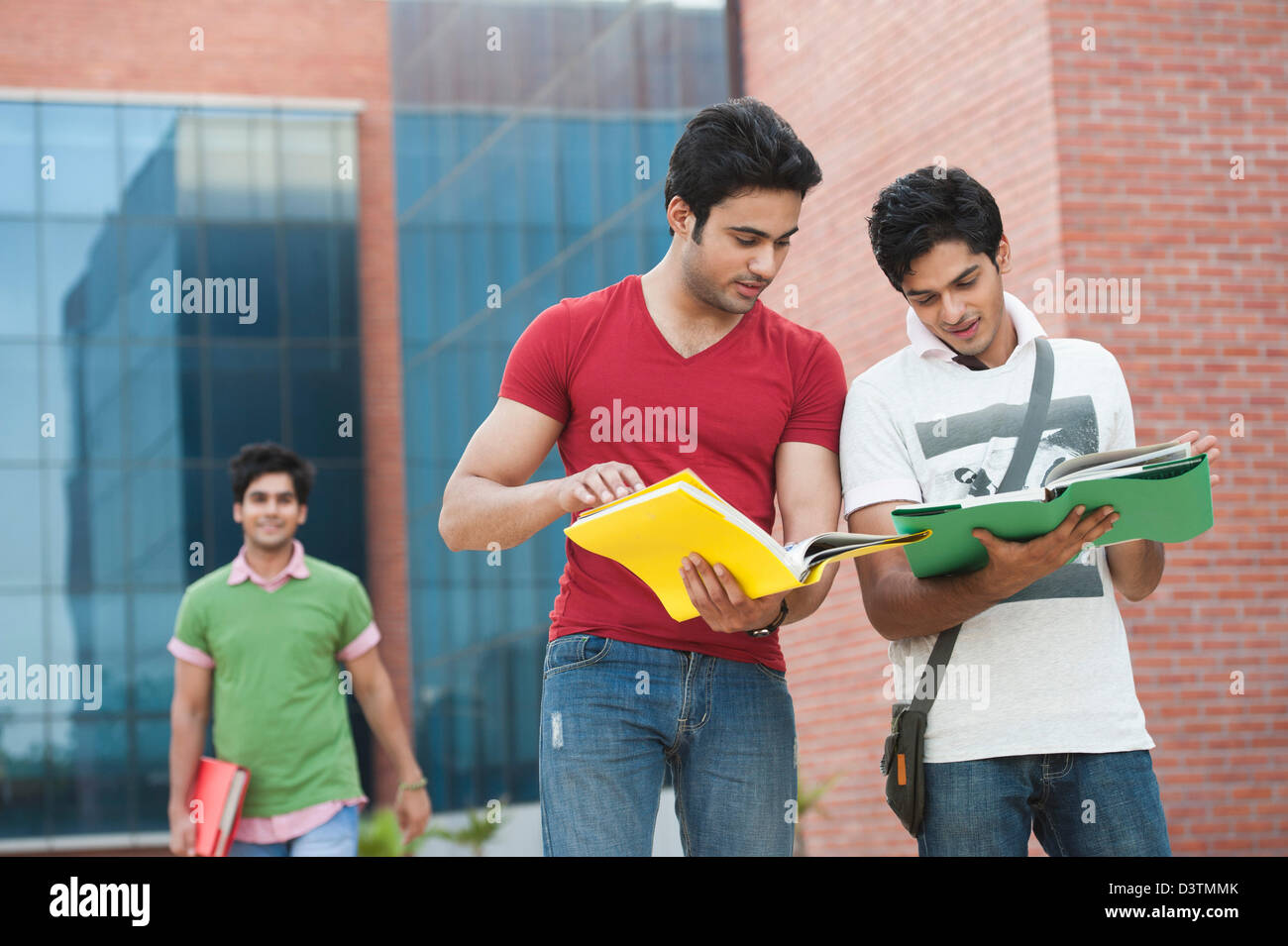 University students reading books in university campus Stock Photo - Alamy