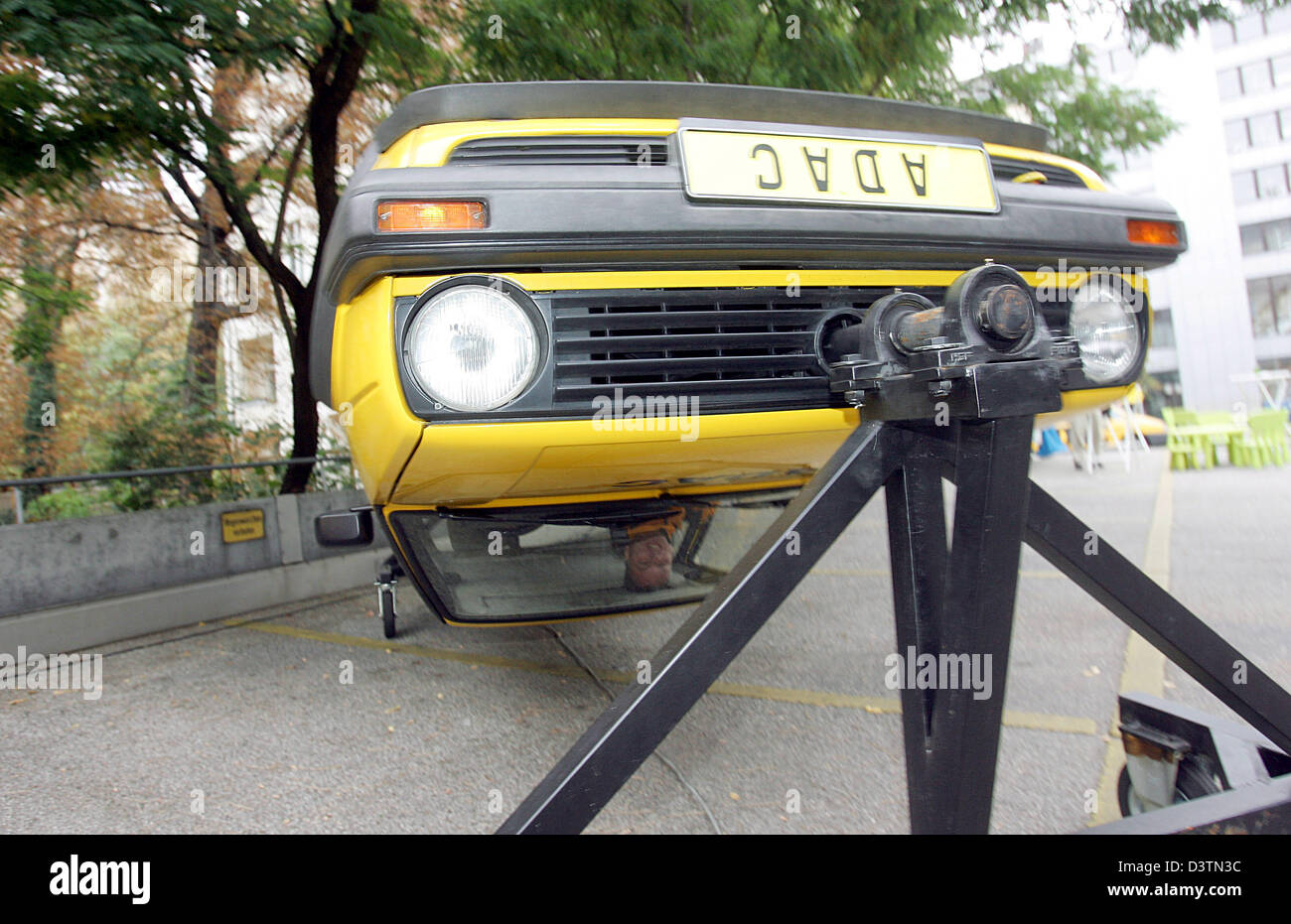 A man sits in a car in a rollover simulator of the 'ADAC' Berlin ...