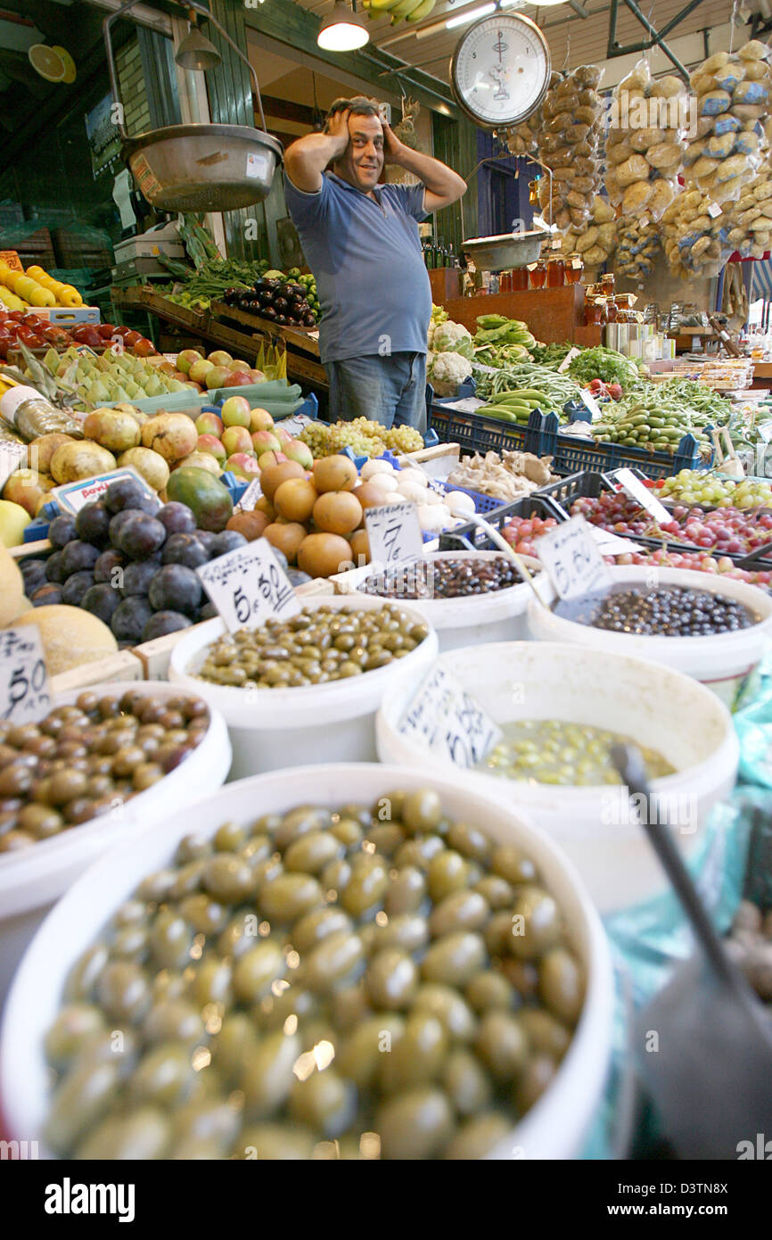 (dpa file) - A vendor of fruits and vegetables stands at his stall in ...