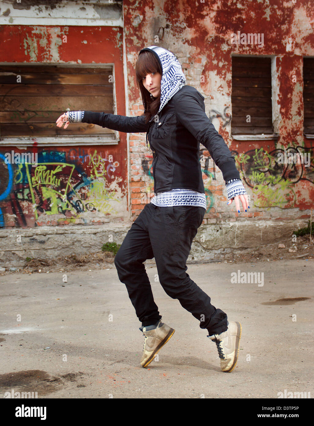 modern style dancer posing behind on Grunge background with graffiti ...