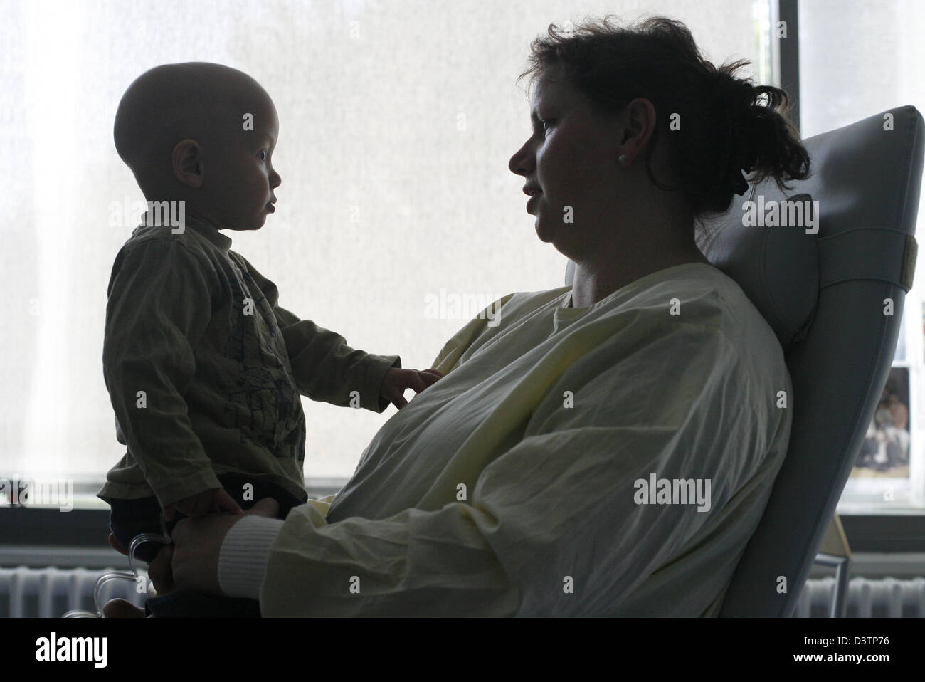 Two-year-old Justing, who suffers from cancer, plays with his mother at ...