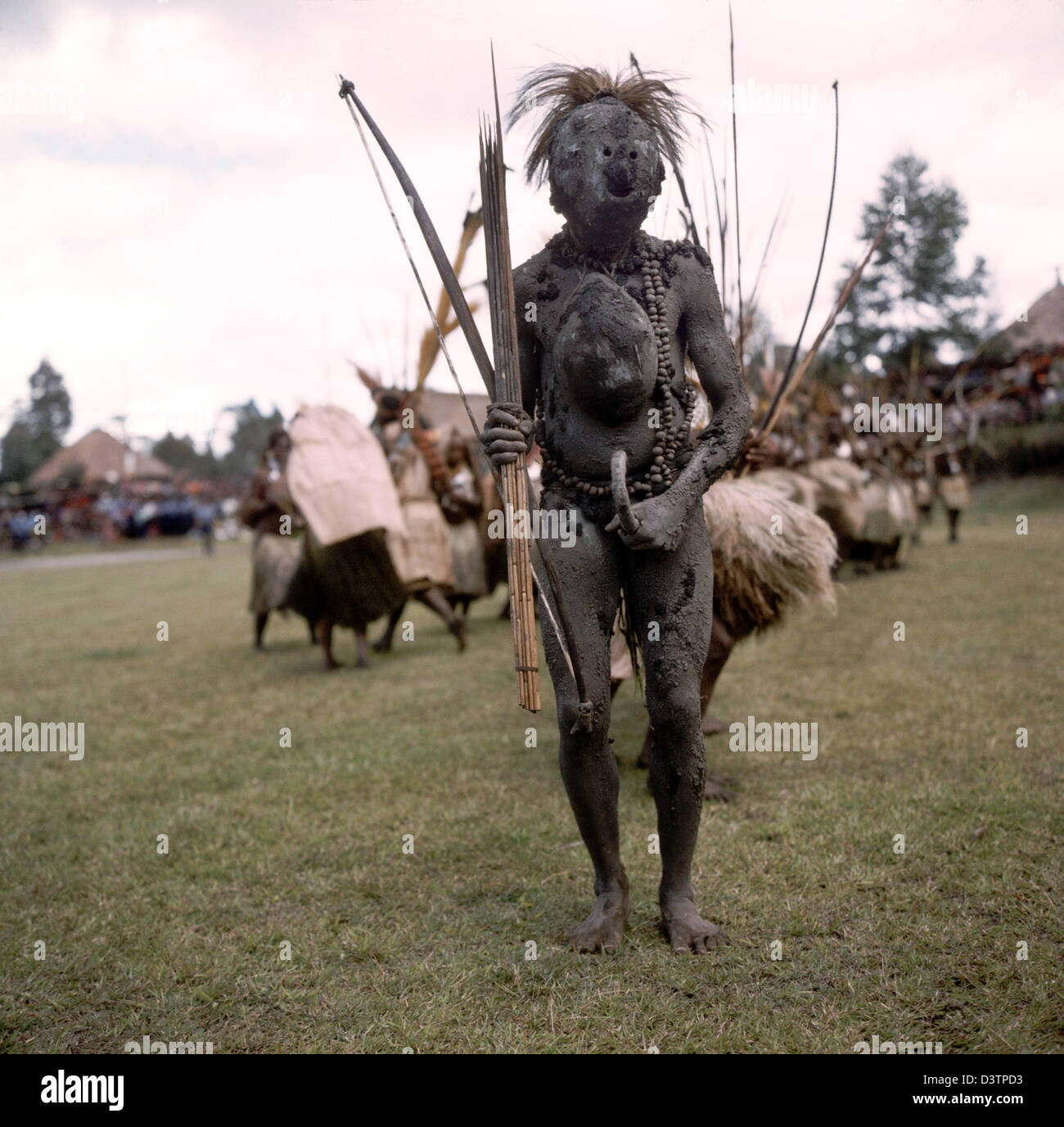 The undated pictures shows three dancing mudmen with maks and bow and ...