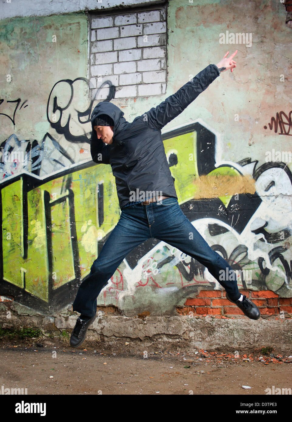 cool looking dancer posing on a grunge background with graffiti Stock ...