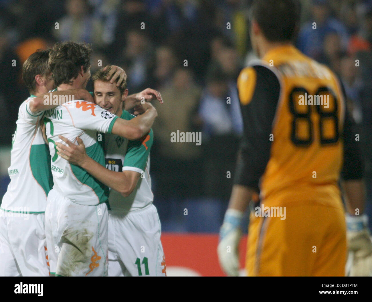 Bremens's Miroslav Klose (C) and Jurica Vranjes (L) embrace the scorer of the 2-0, Frank Baumann ...