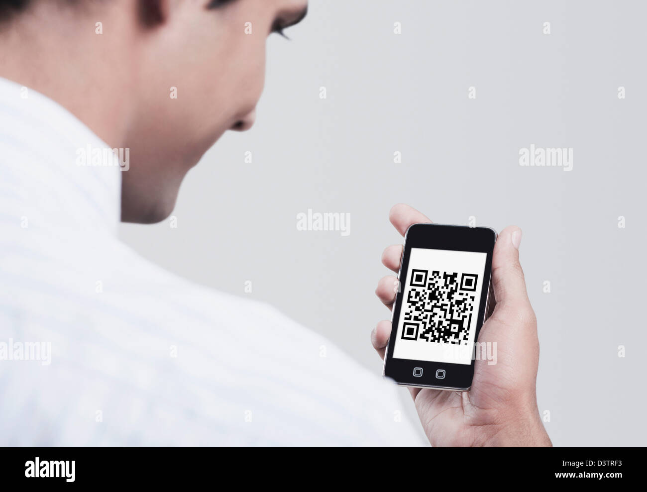 Man looking at the 2D Barcode on a mobile phone Stock Photo - Alamy