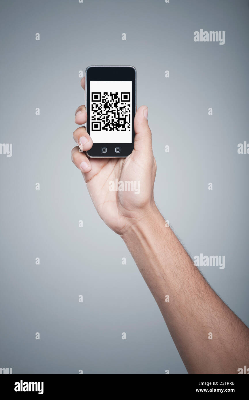 Persons hand holding a mobile phone with 2D Barcode on the screen Stock ...