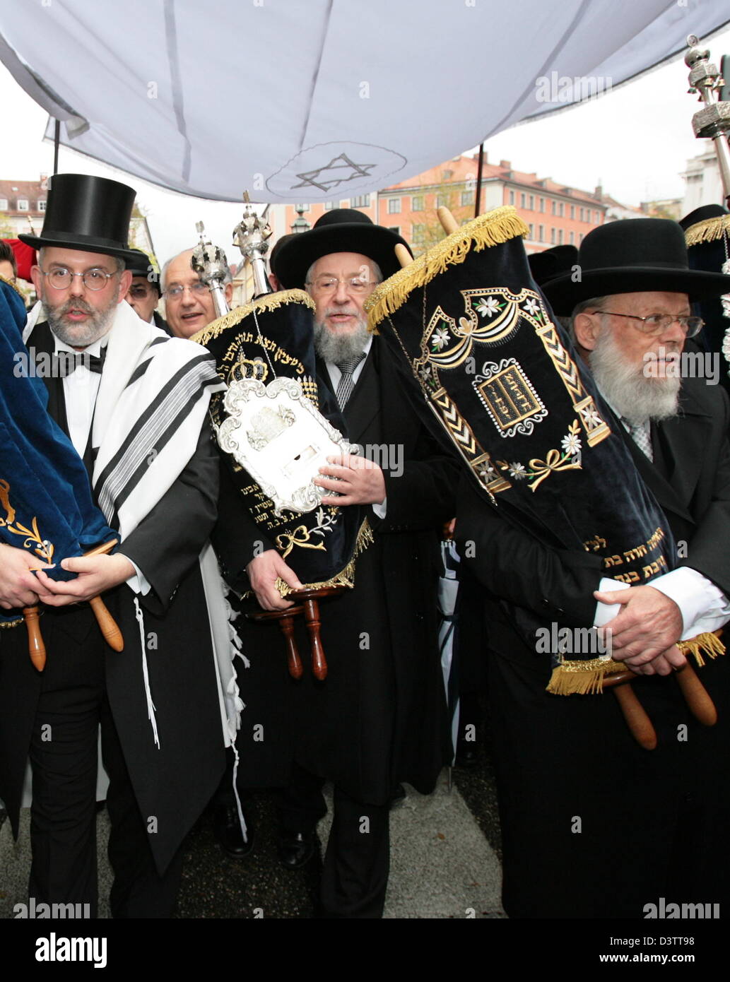 Rabbis carry Torahs during a procession leading to the new main ...