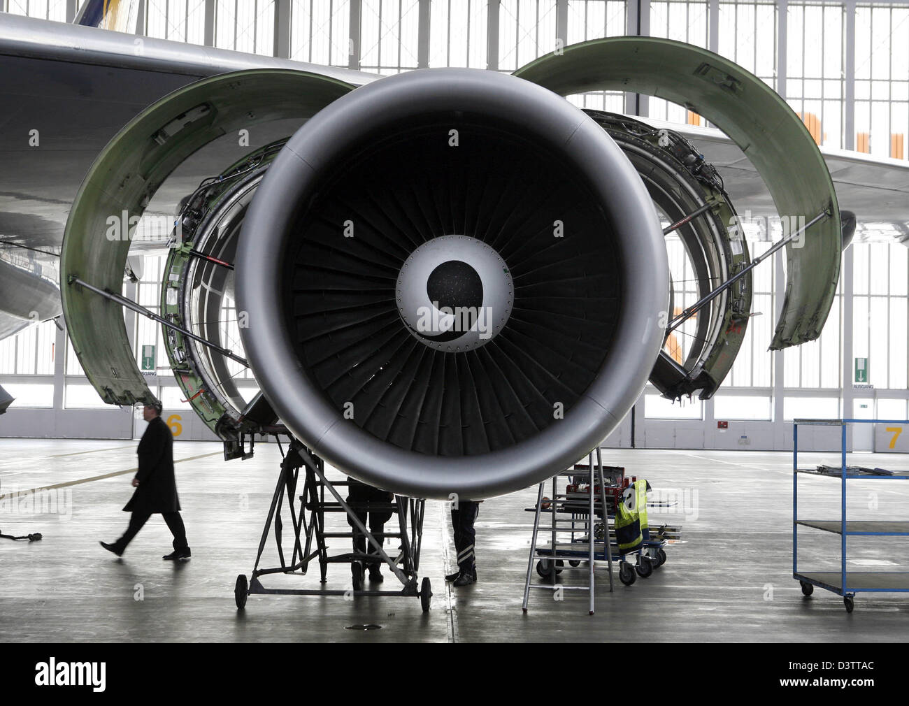 A technician of Lufthansa Technik examines the engine of a Boeing 747 ...