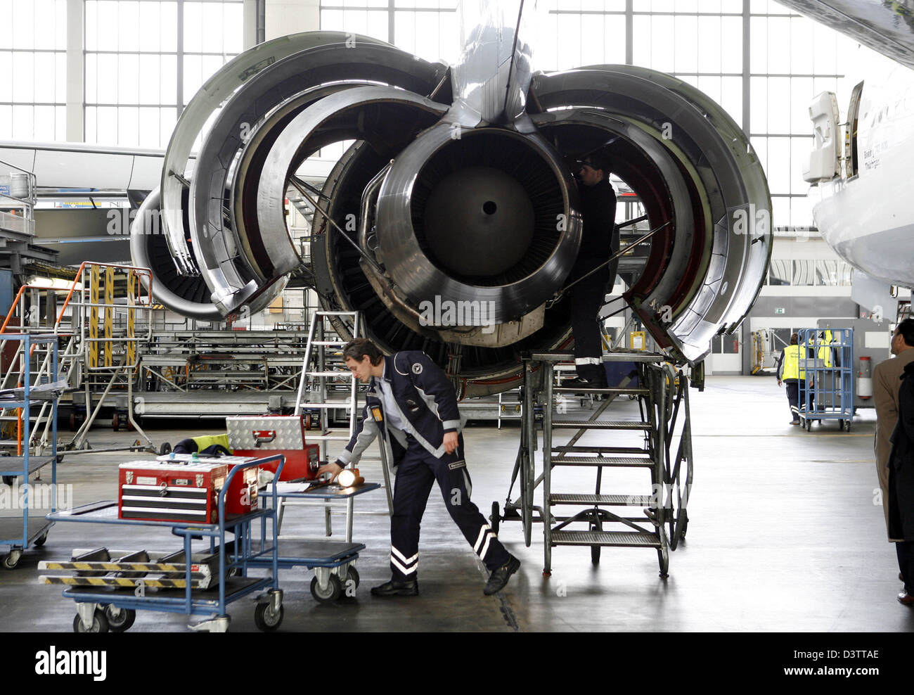 A technician of Lufthansa Technik examines the engine of a Boeing 747 ...