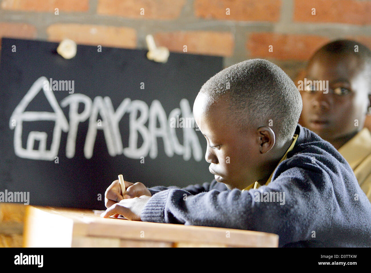 A boy writes in a class room near Kigali, Rwanda, 02 November 2006. The ...