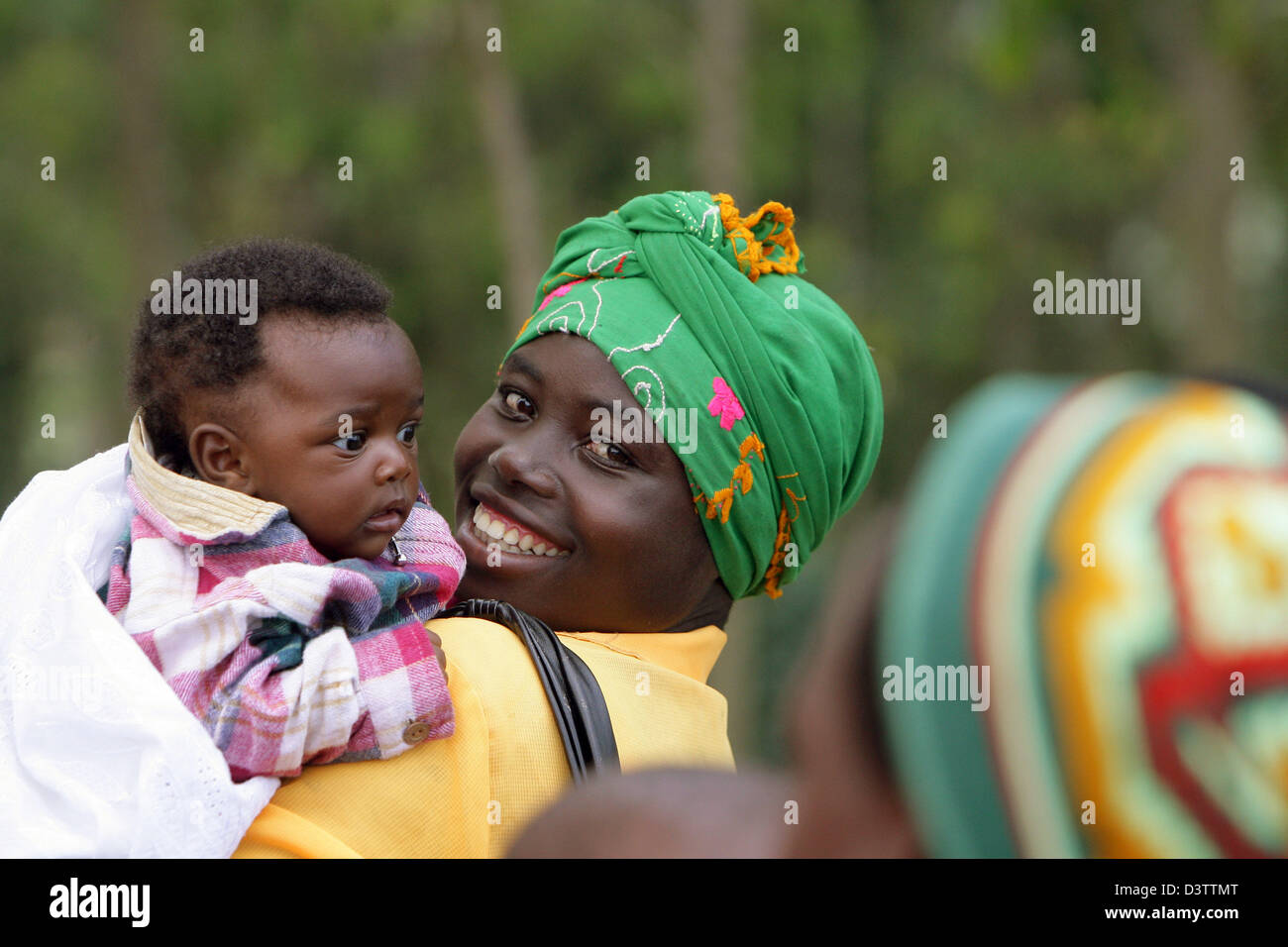 A Rwandan mother smiles carrying her baby near Kigali, Rwanda, 02 ...