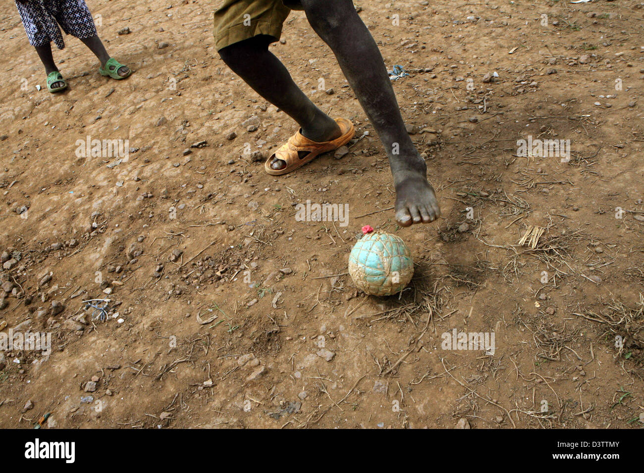Rwandan children play barefoot or in sandals with a self-made football ...