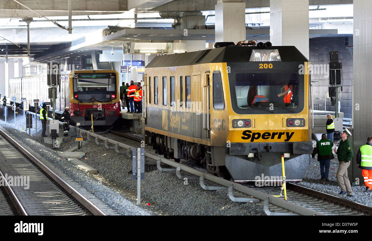 Emergency forces examine the damaged railcar at the Berlin station ...