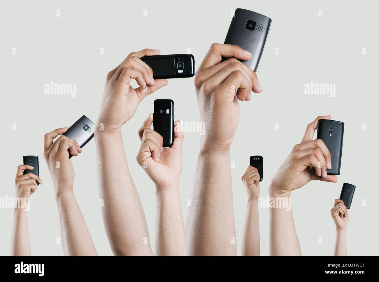 People's hands holding mobile phones Stock Photo - Alamy