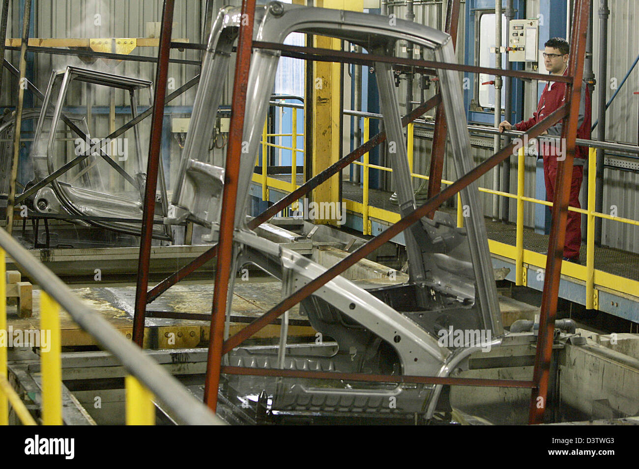 The bodies of forklifts pictured in the dipping bath of the Linde paint ...