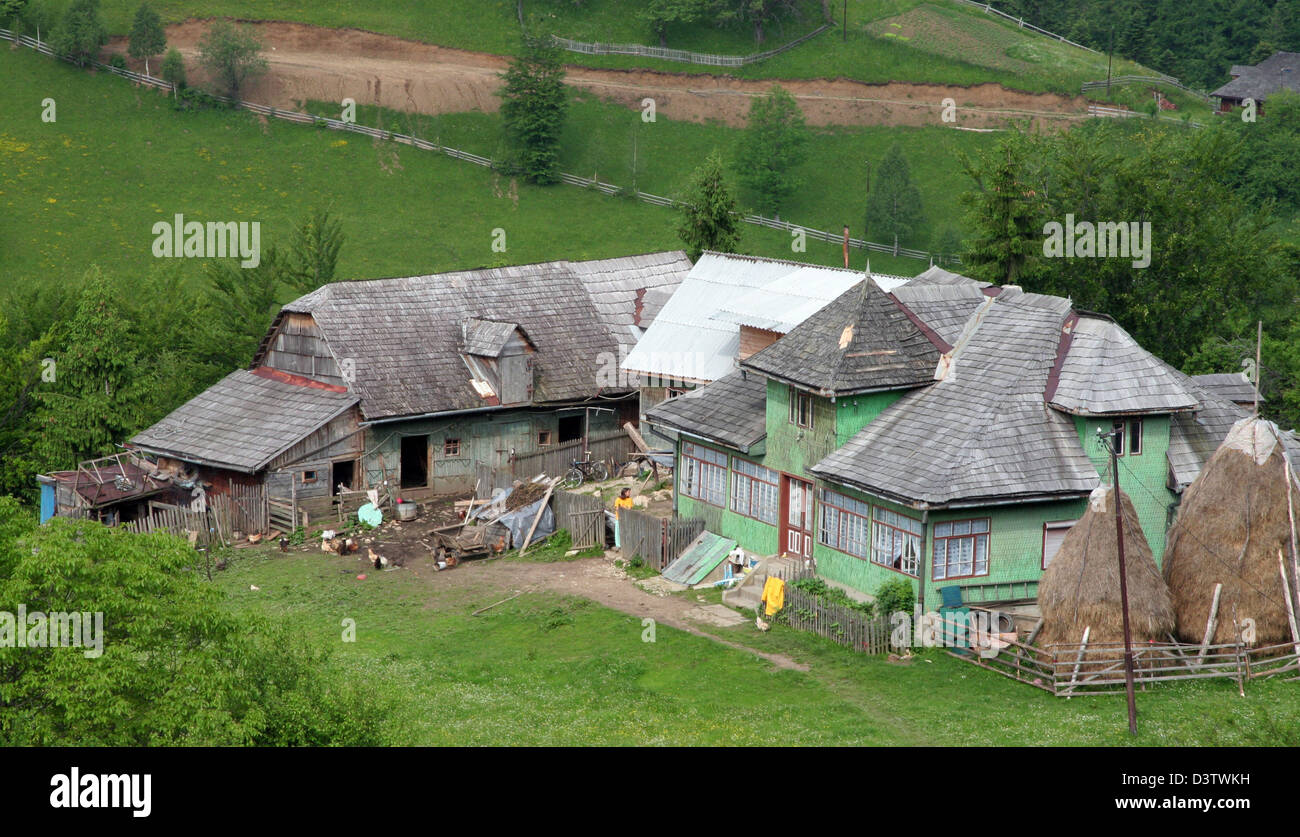 The photo shows an old wooden farm house in Magura, Transylvania ...