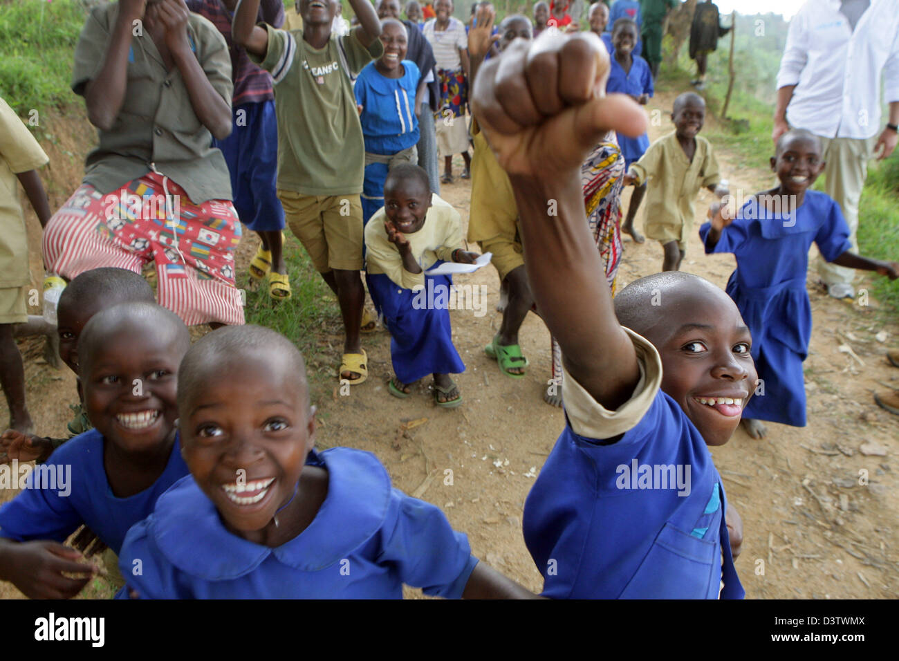 Ruandian boys and girls, some of them in blue school uniforms, pose ...