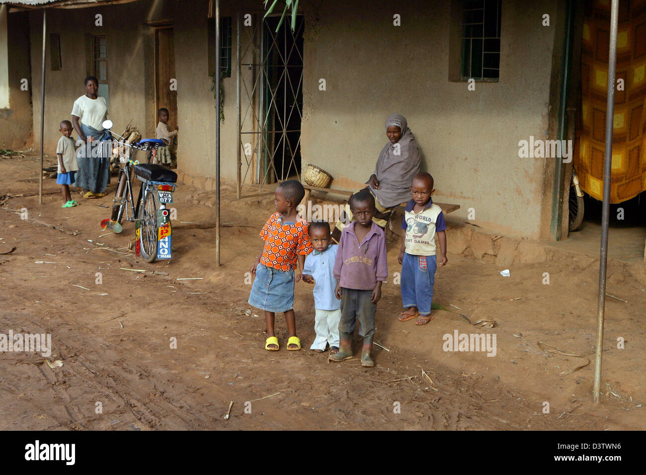 The photo shows a street scene with children in a village near Kigali ...