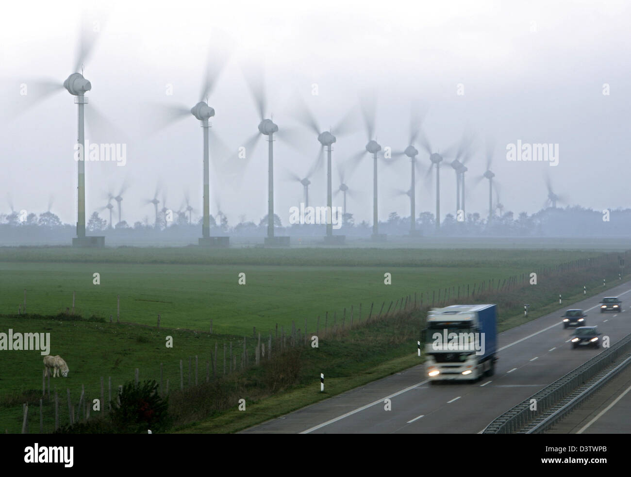 The photo shows rotating wind turbines during a storm at the wind ...