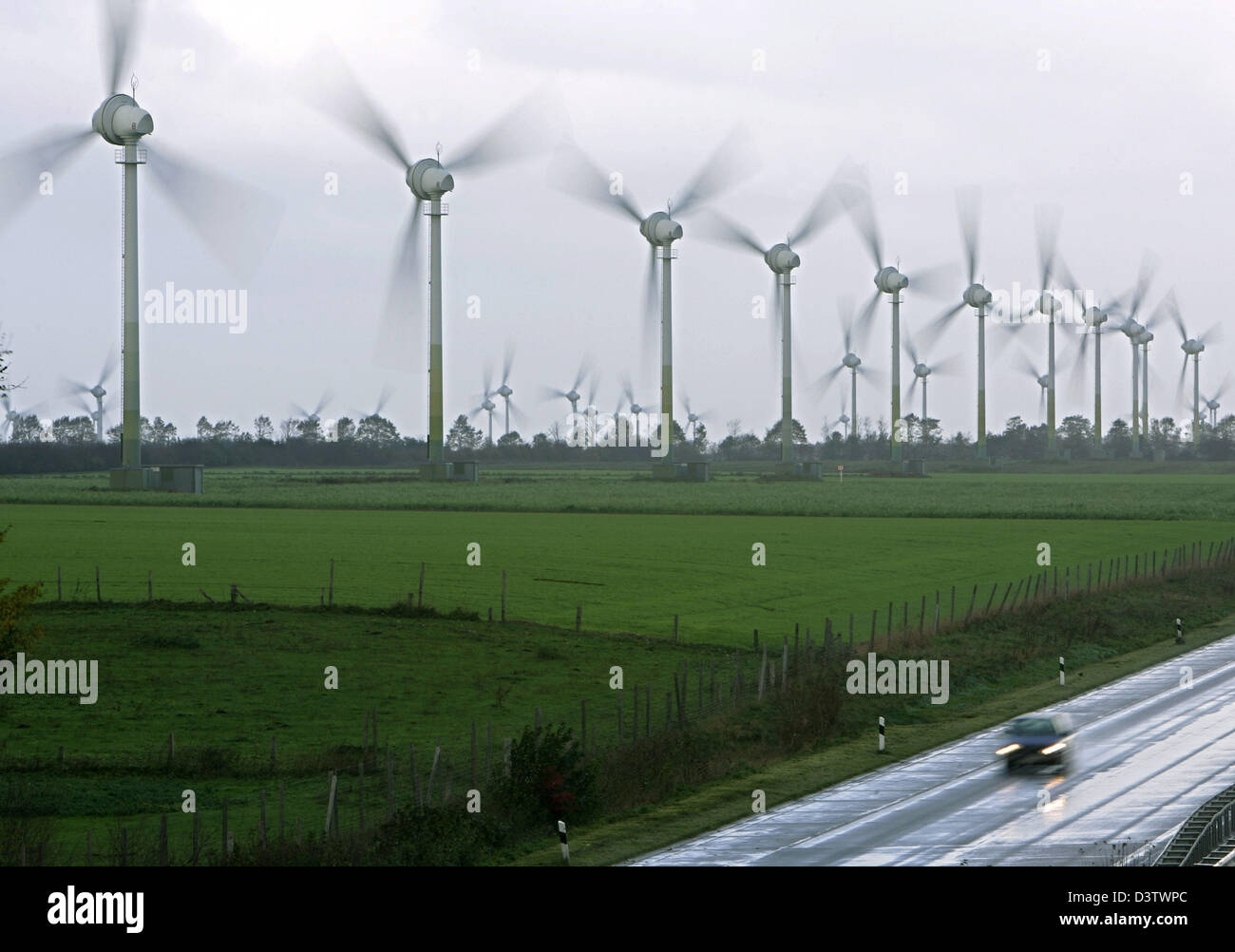 The photo shows rotating wind turbines during a storm at the wind ...