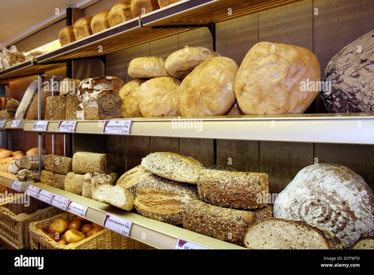 The picture shows a selection of different types of bread in a bakery ...