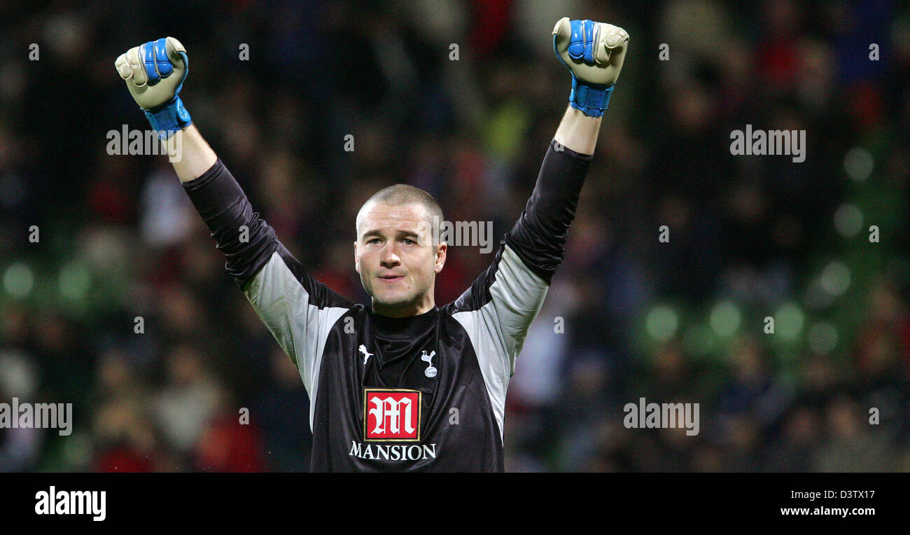 Tottenham goalie Paul Robinson cheers after his team wins the UEFA Cup ...
