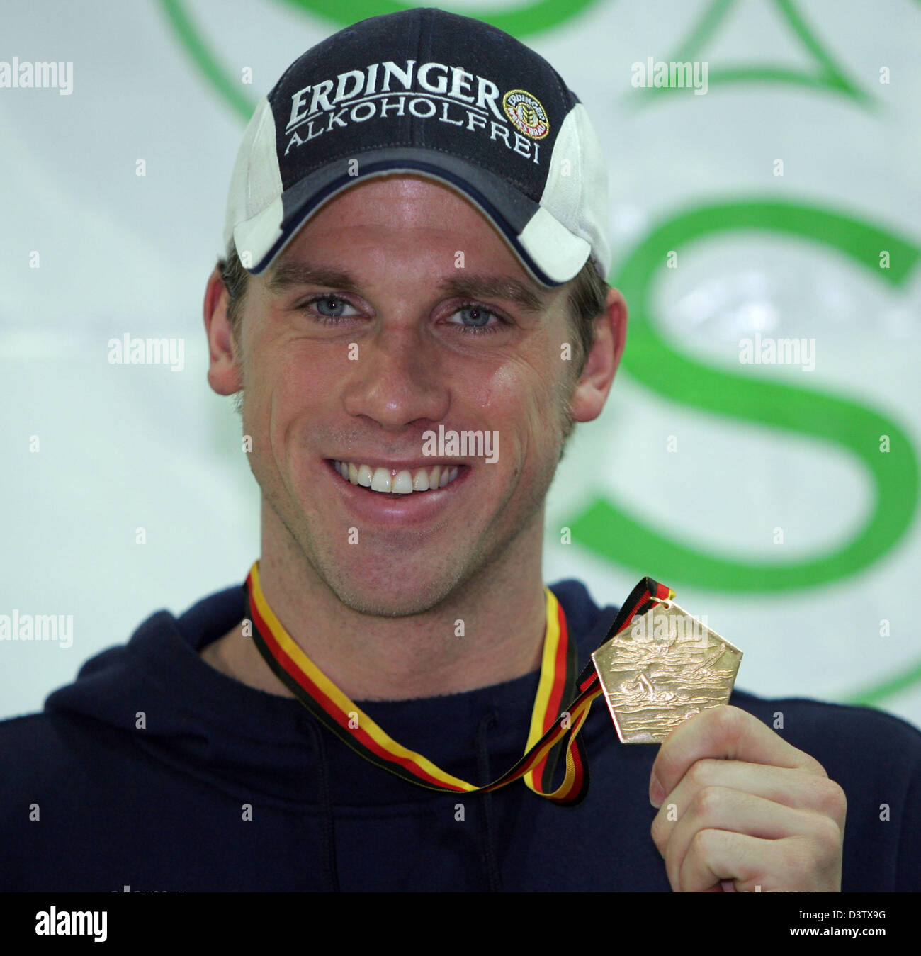 German pro swimmer Thomas Rupprath smiles with his gold medal for ...