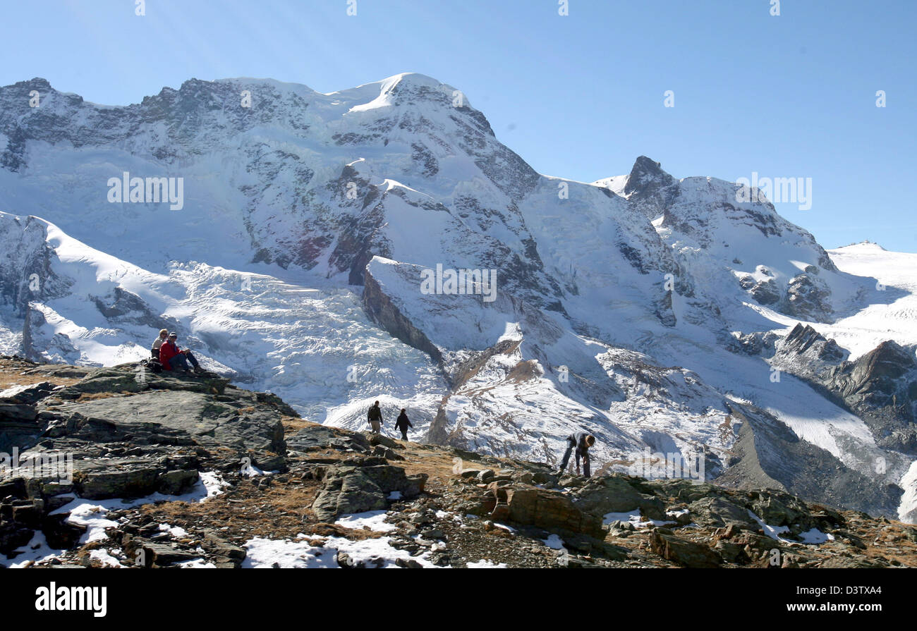 Hikers pictured on the Gorner ridge under the Smaller Matterhorn (L ...