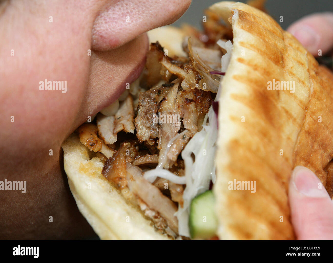 A young woman takes a bite from a doner kebab in Hanover, Germany, 27 ...