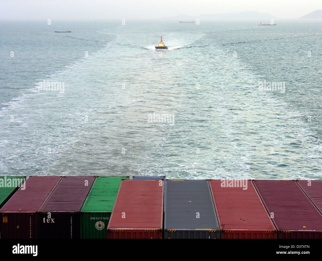 The photo shows the fairway of and containers piled onboard the German ...