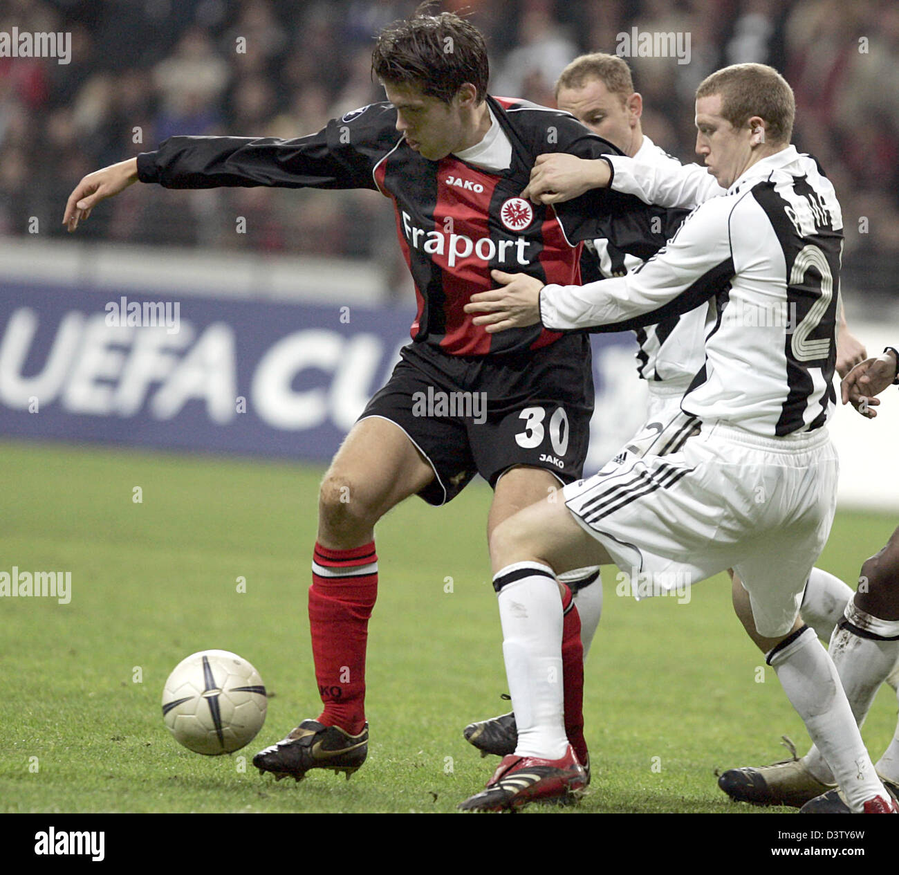 Frankfurt's Benjamin Huggel (L) is pulled back by Peter Ramage of ...