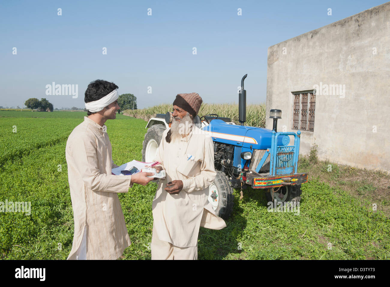 Farmer giving money to another farmer as agriculture loan, Sonipat ...