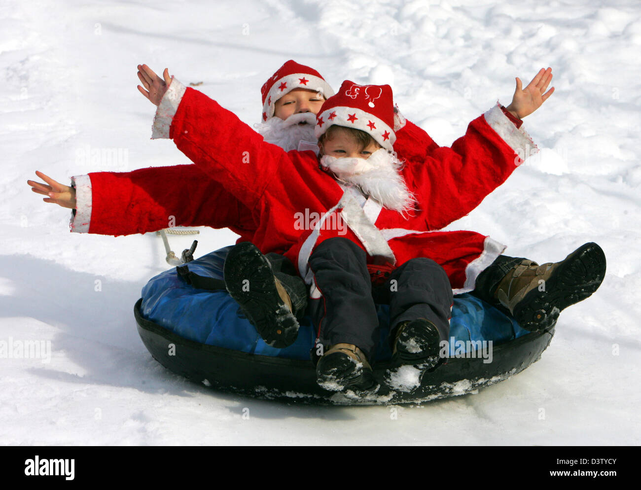 Visitors dressed as Santa Claus ride a tryre at the Europapark Rust ...