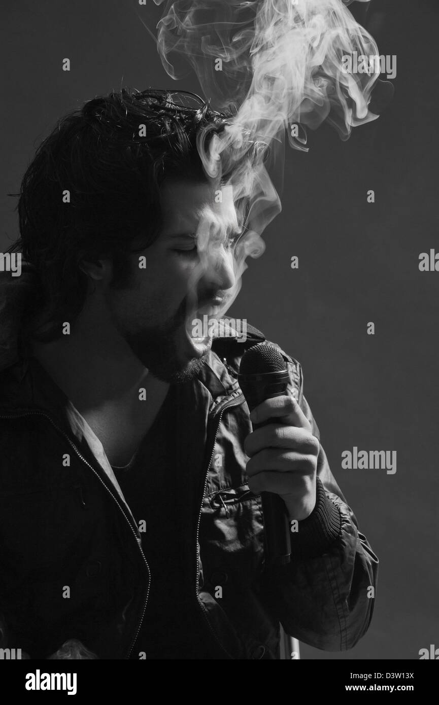 Indian young man singing microphone Black and White Stock Photos ...