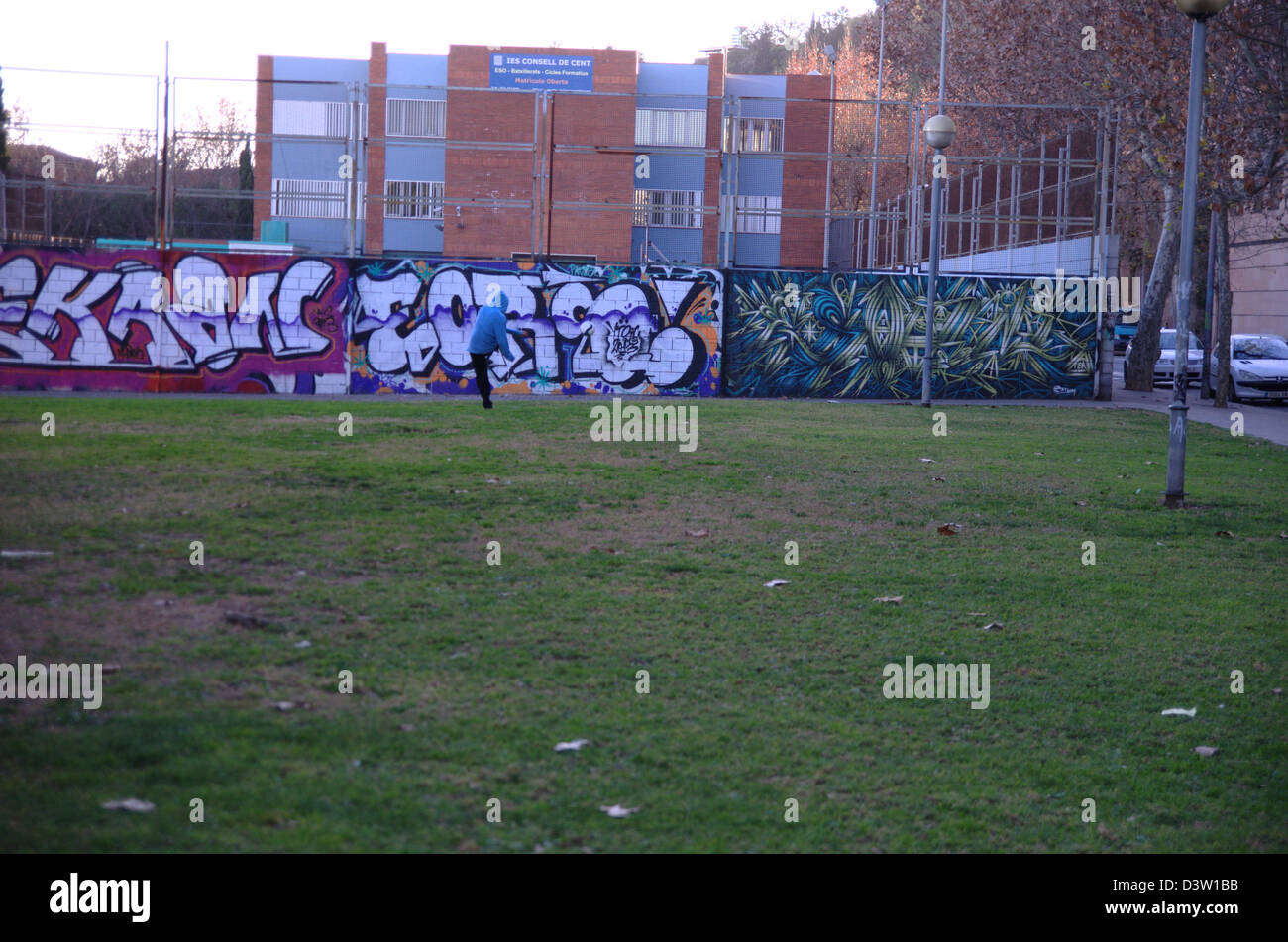 Graffiti in Paral·lel Avenue in Barcelona. Boy playing soccer in ...