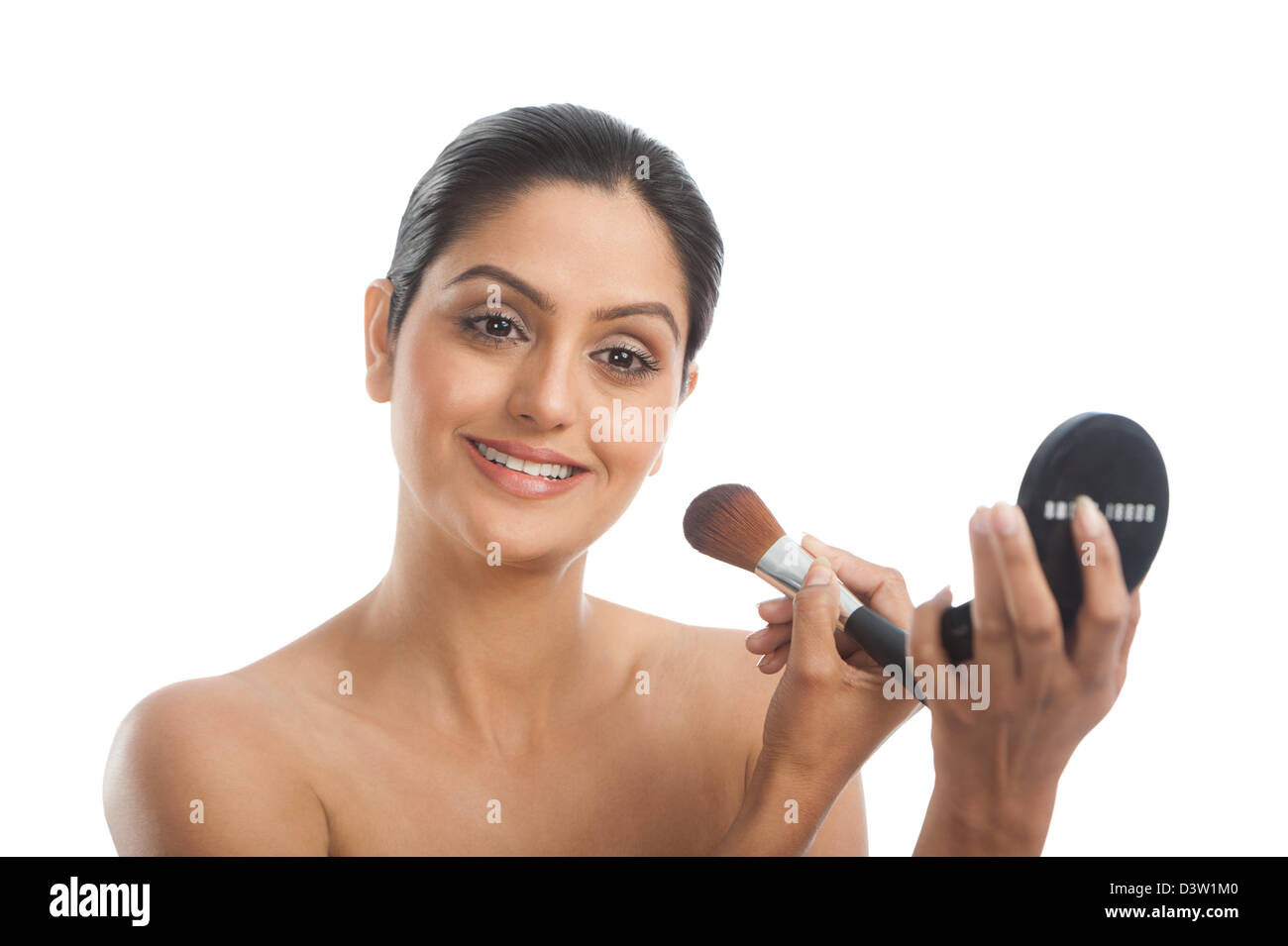 Woman applying up brush Cut Out Stock Images & Pictures - Alamy