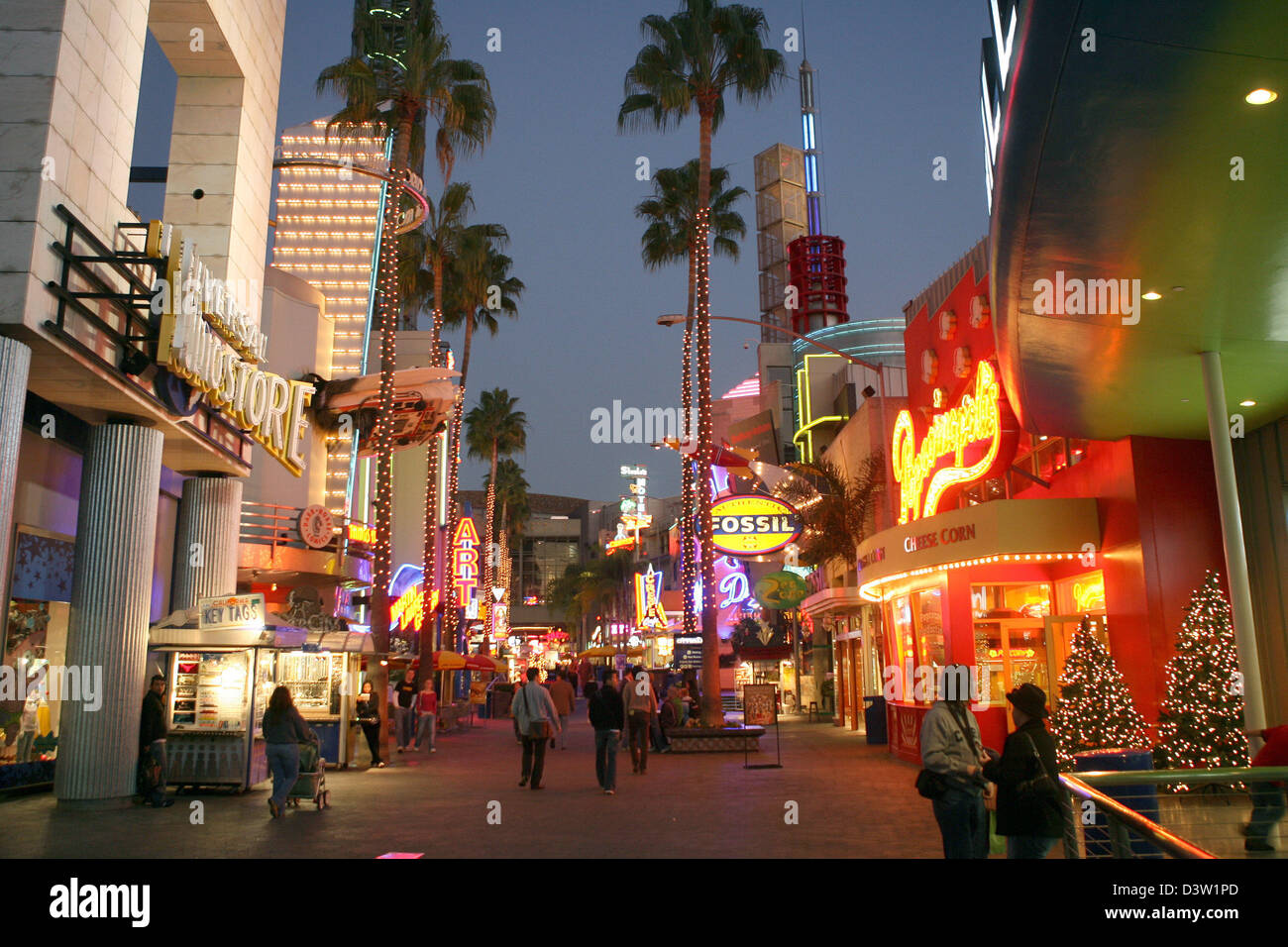 The picture shows visitors on a street illuimated by many neon signs at ...