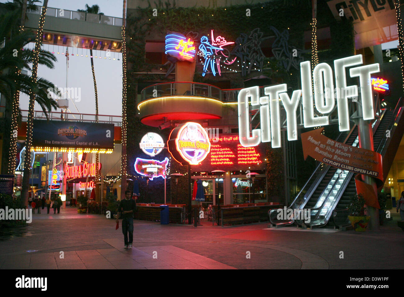 The picture shows visitors on a street illuimated by many neon signs at ...