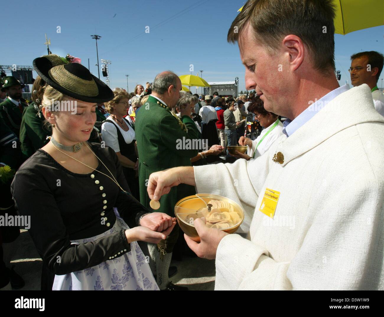 A believer receives the holy communion during the mass celebrated by ...