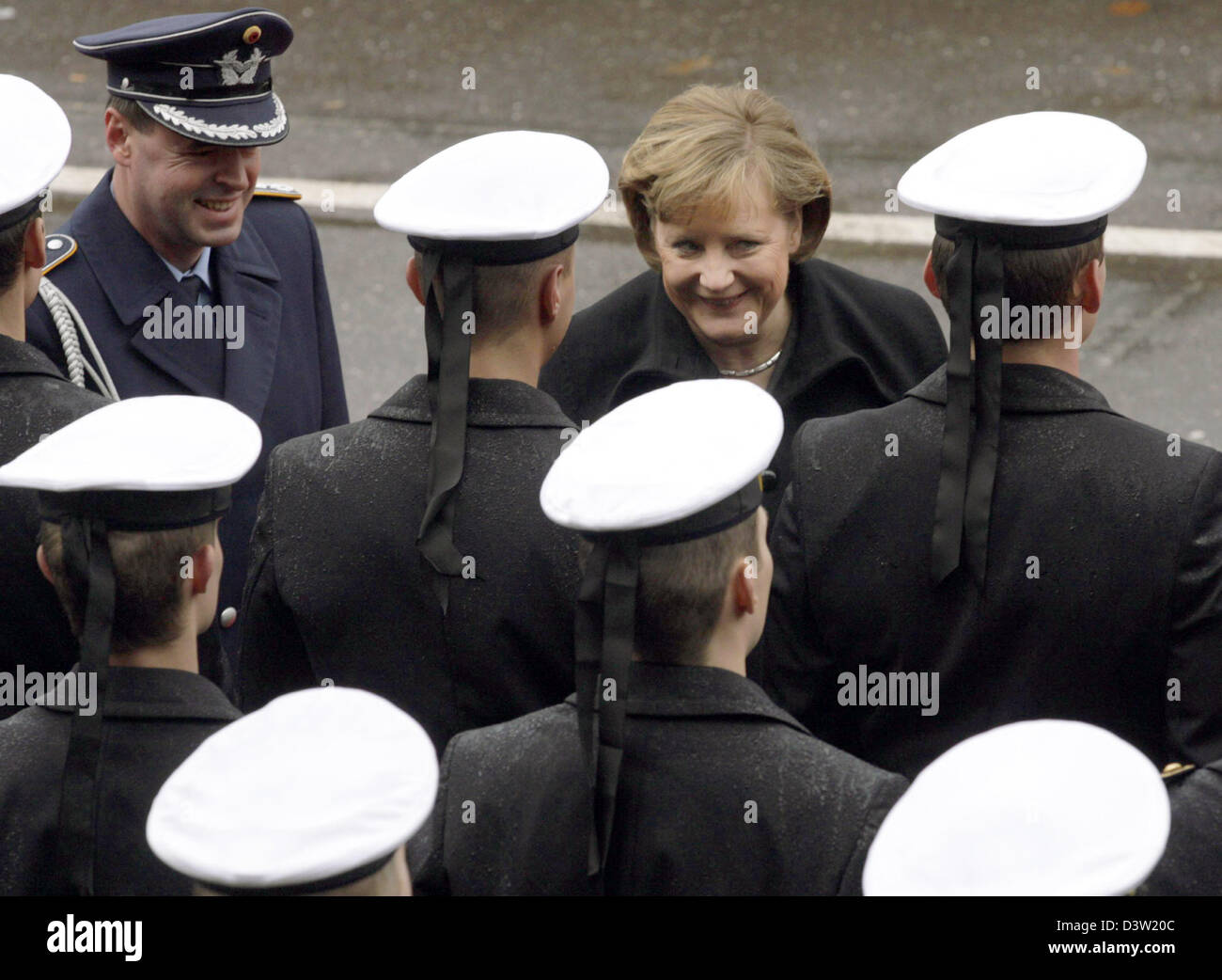 German Chancellor Angela Merkel (C) chats with the guard of honour at ...