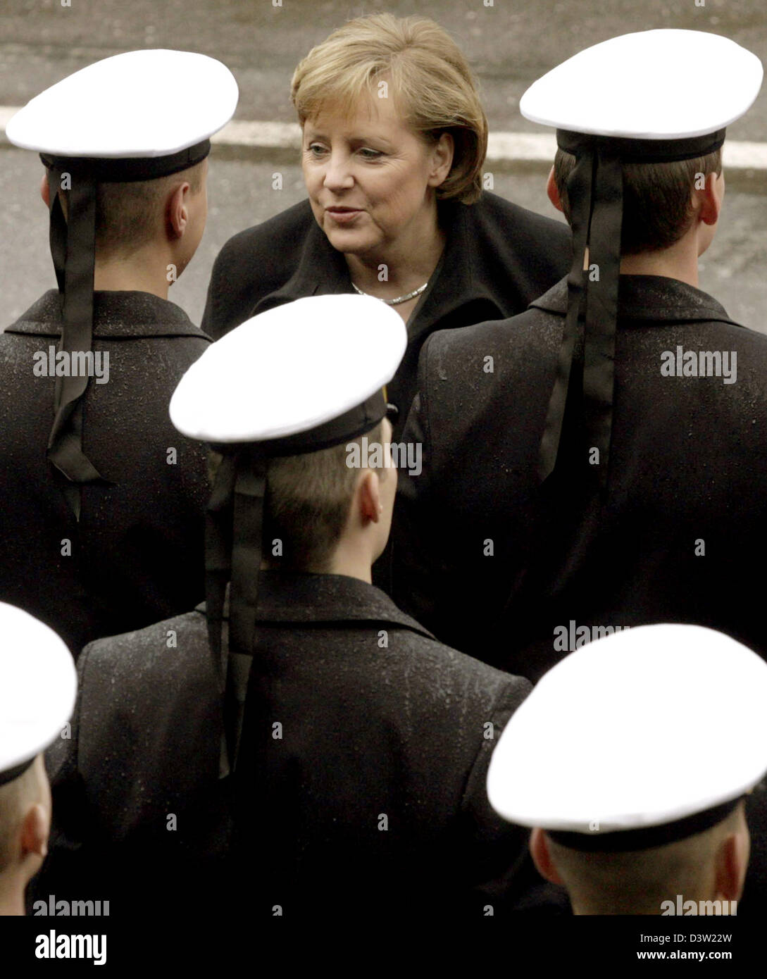 German Chancellor Angela Merkel (C) chats with the guard of honour at ...