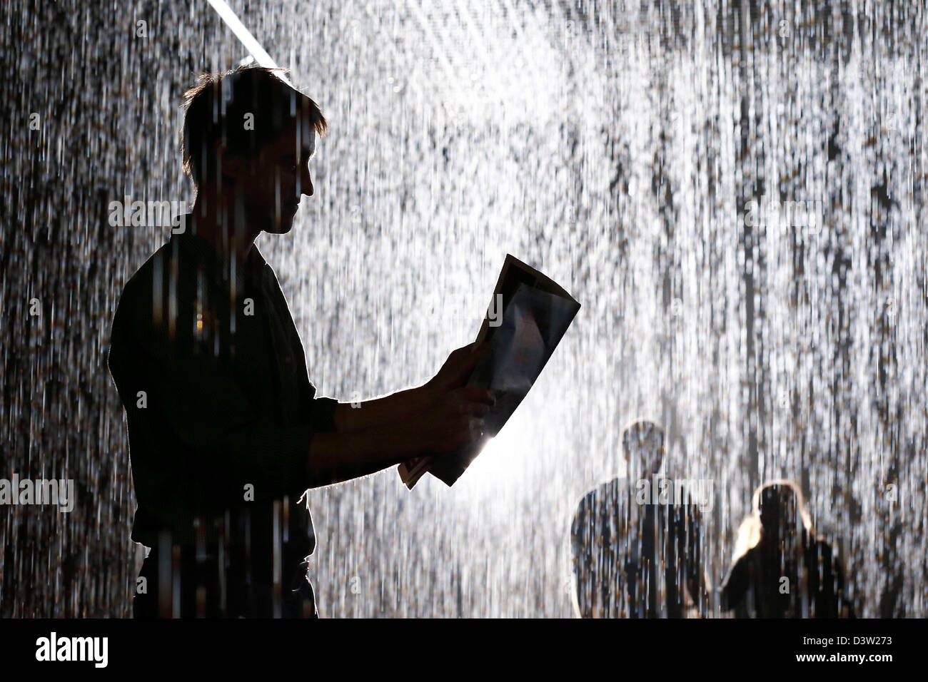 People interact with the 'Rain Room' art installation by 'Random ...