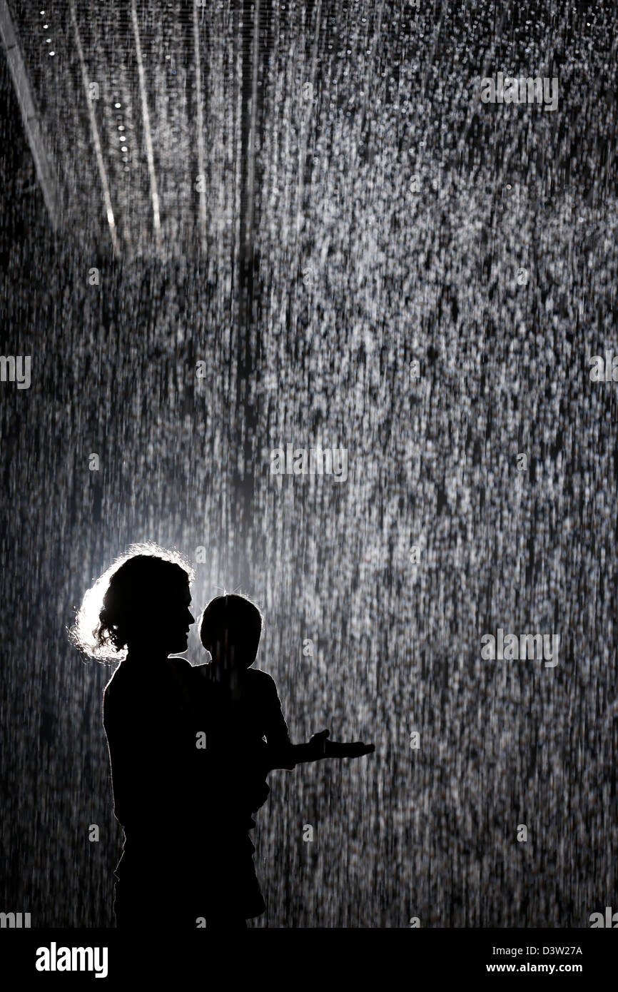 People interact with the 'Rain Room' art installation by 'Random ...