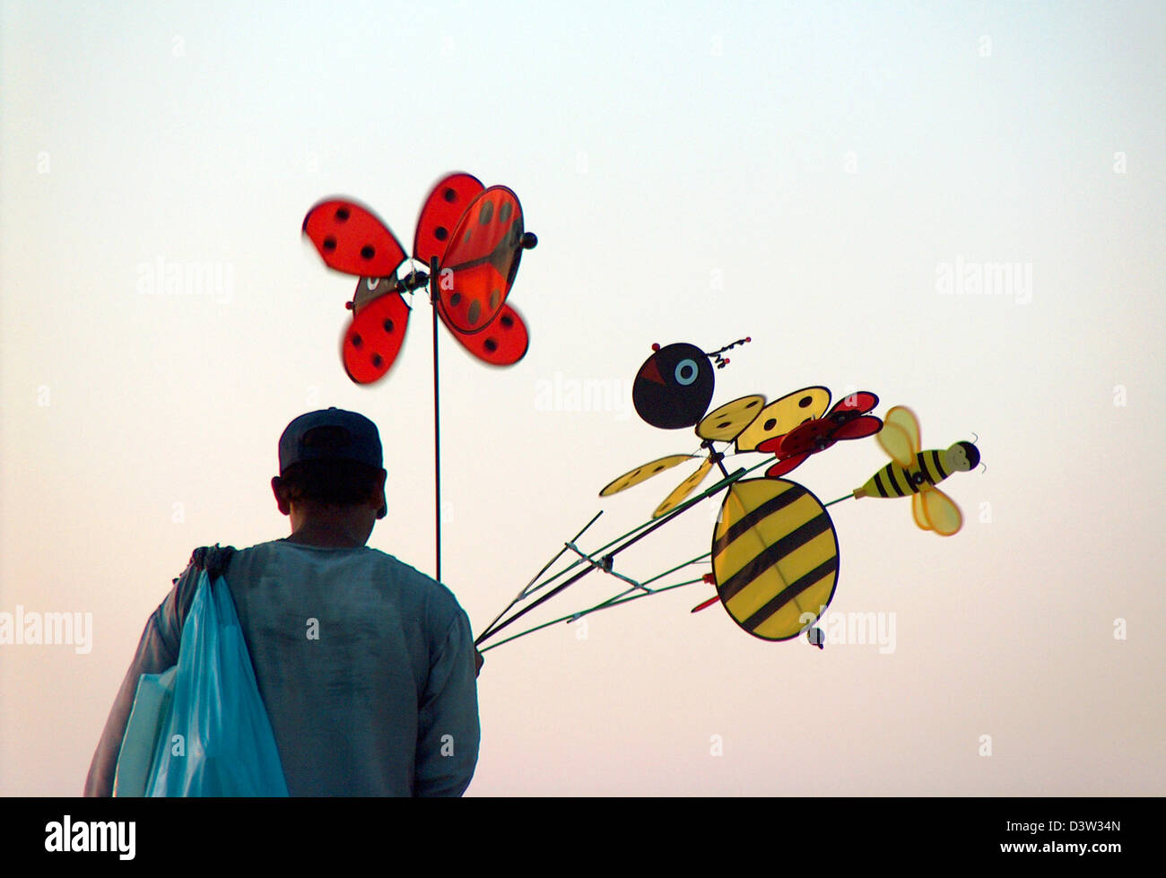 A hawker offers wind toys at the beach of Rome, Italy, 19 September ...