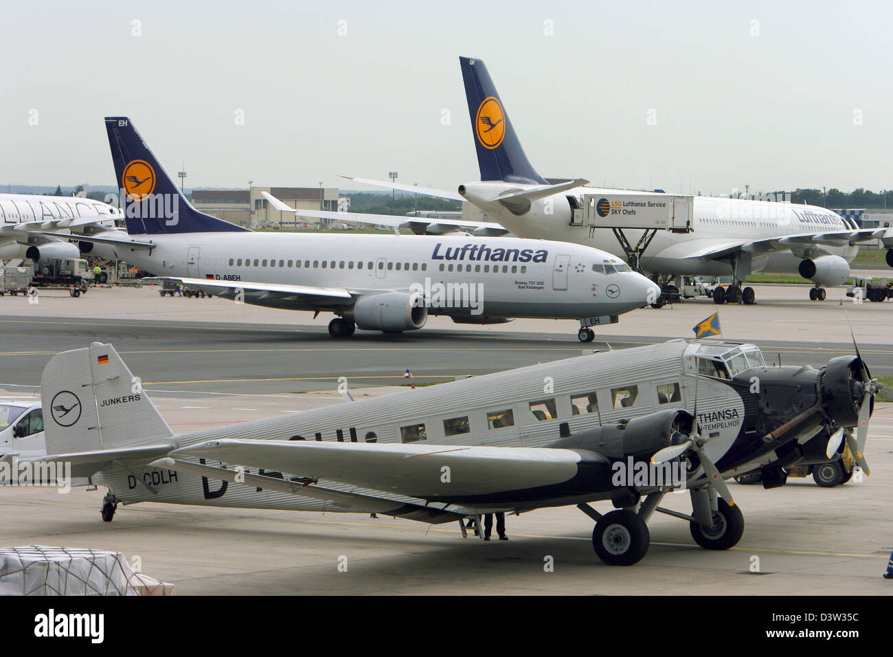 An oldtimer plane Junkers Ju 52 (front) starts the engines for a ...