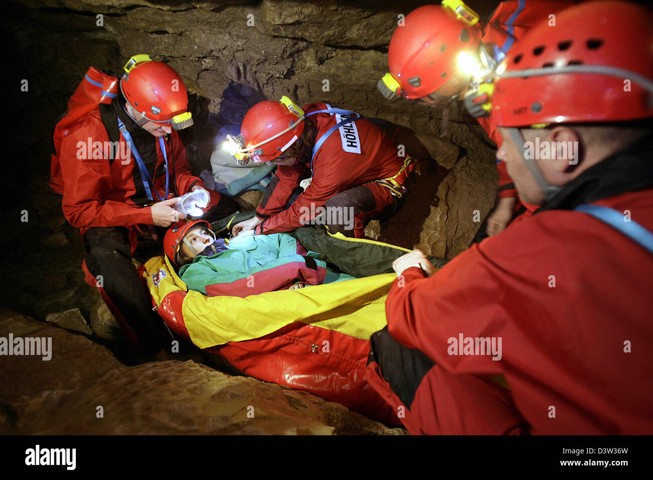 Four members of a cave rescue team simulate the salvation of an injured ...