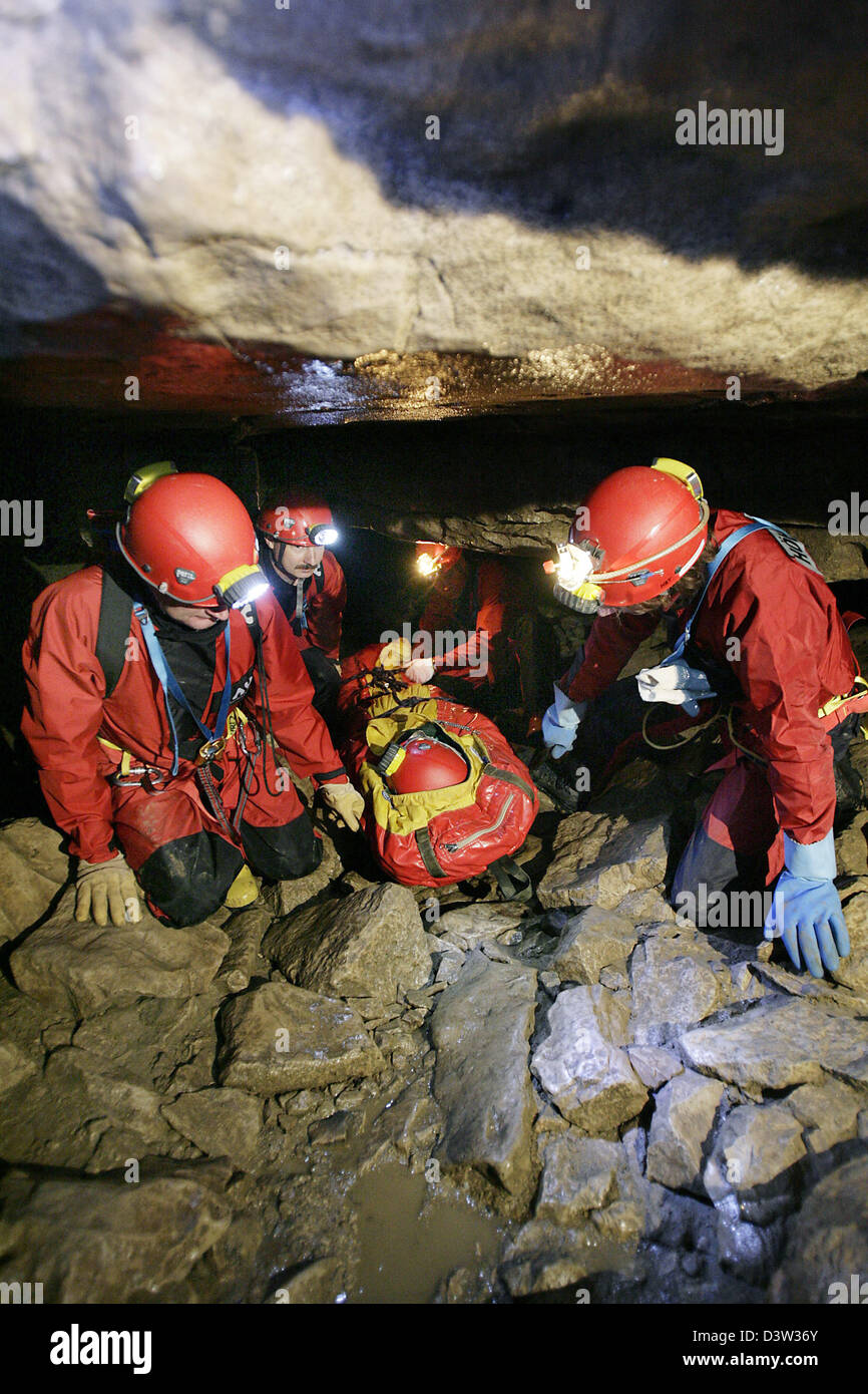 Four members of a cave rescue team simulate the salvation of an injured ...