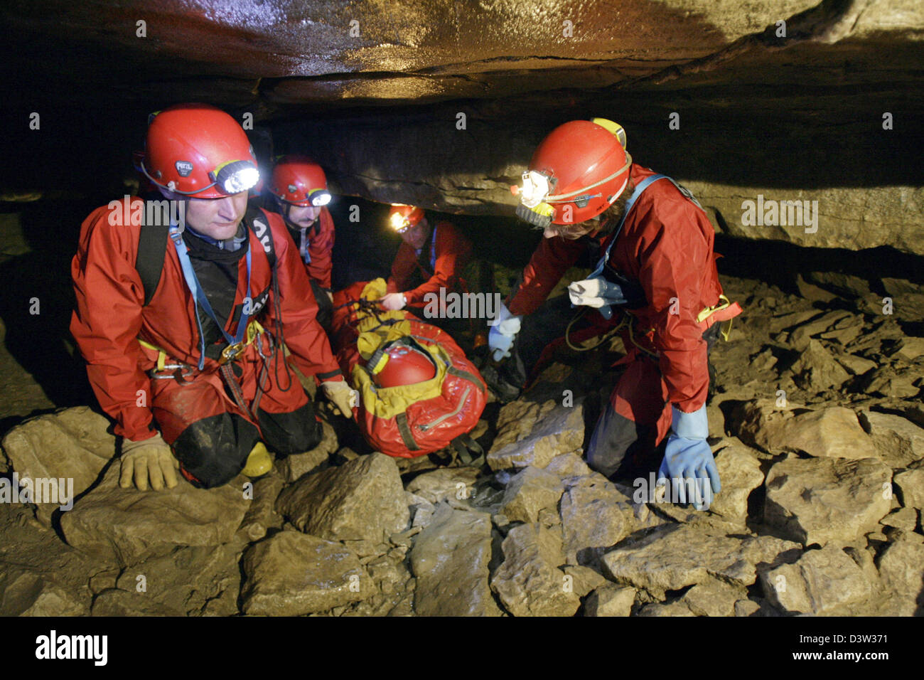 Four members of a cave rescue team simulate the salvation of an injured ...