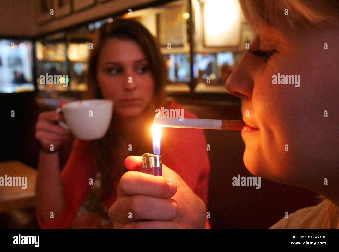 Two young women smoke cigarettes hi-res stock photography and images ...